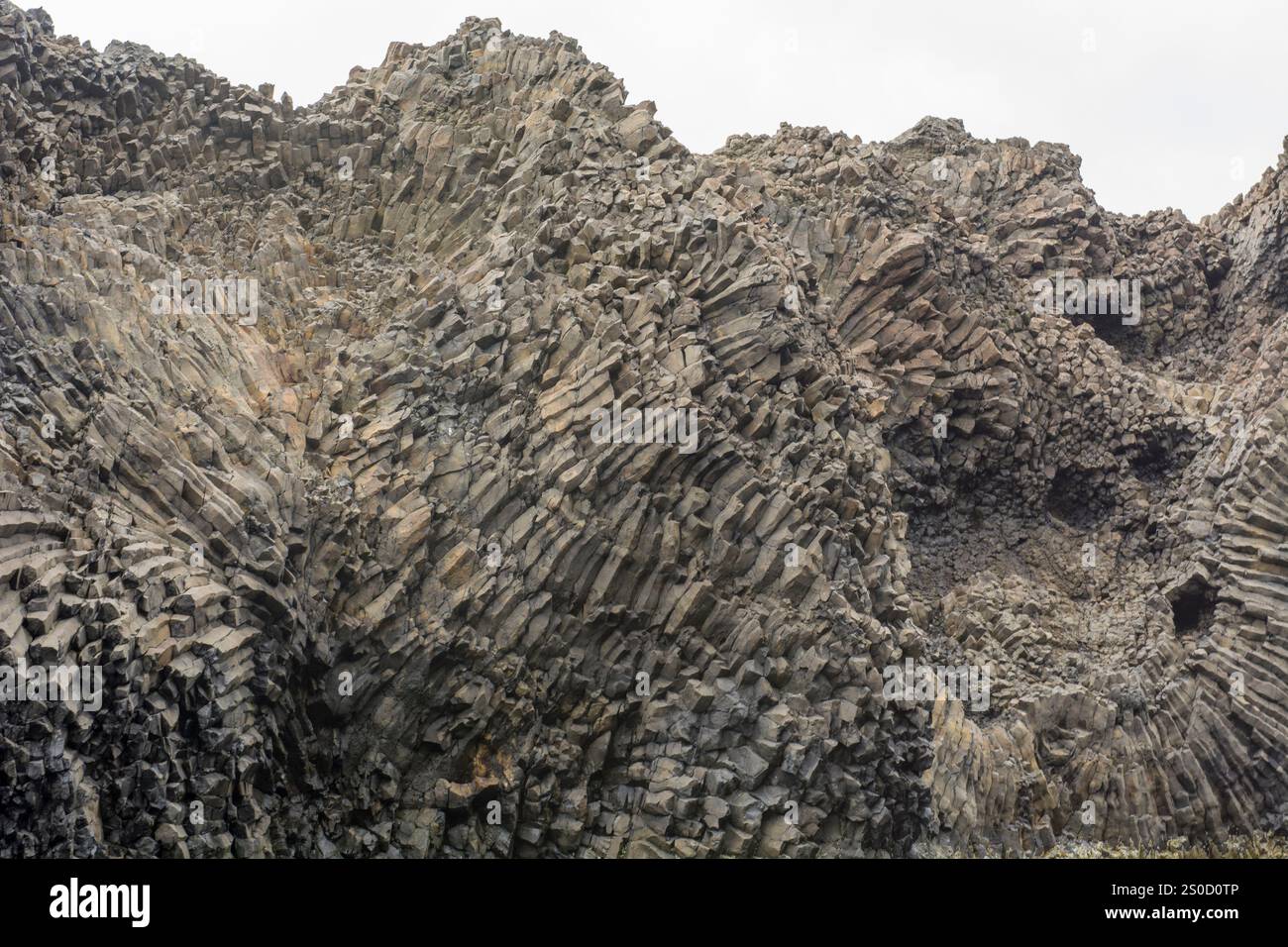 A striking natural formation of basalt columns on Disko Island, Greenland, showcasing the island ...
