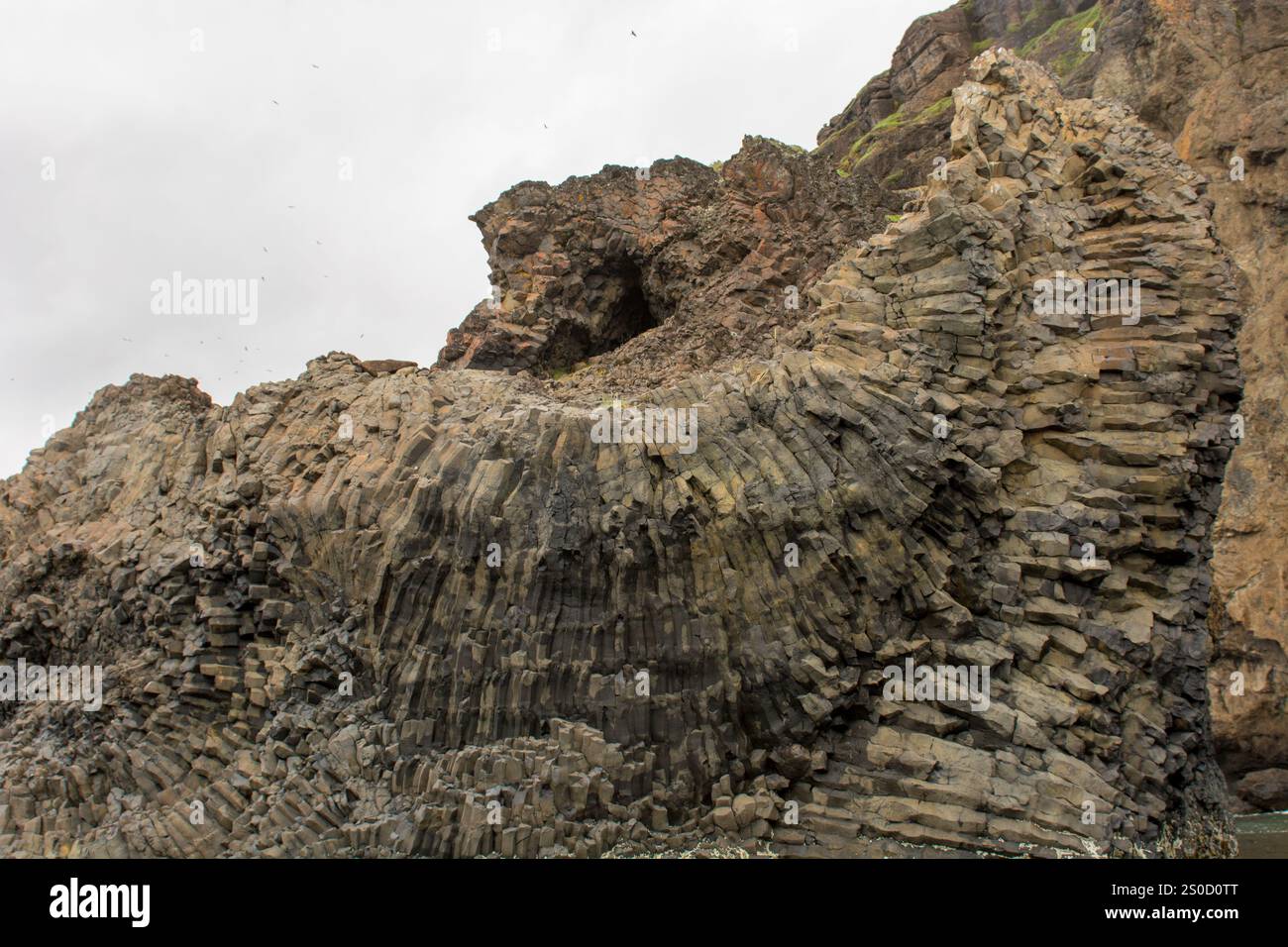 A striking natural formation of basalt columns on Disko Island, Greenland, showcasing the island ...