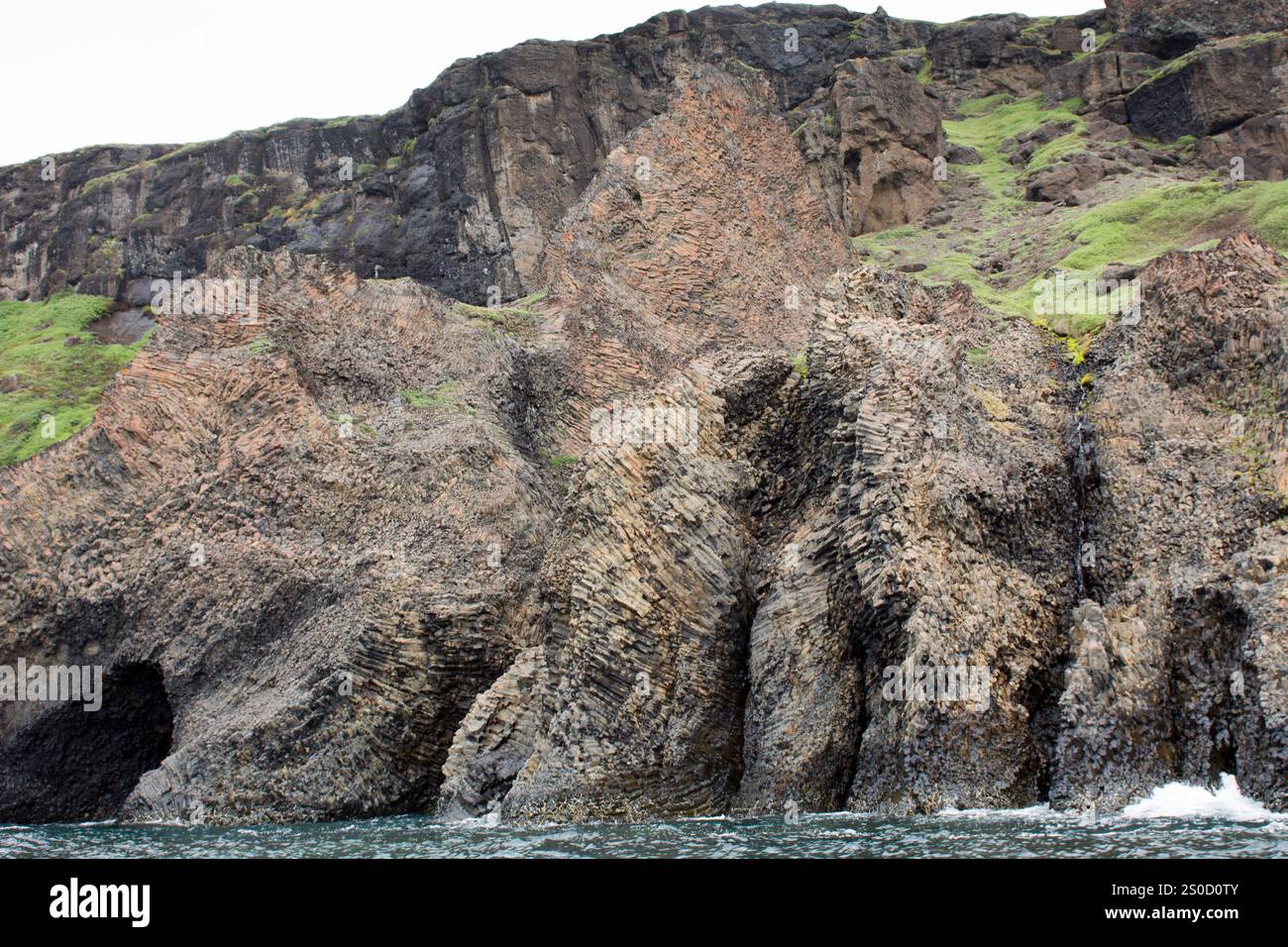 A striking natural formation of basalt columns on Disko Island, Greenland, showcasing the island ...