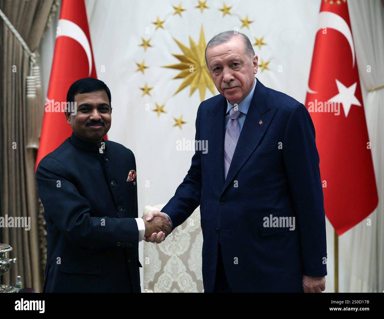 Turkish President Recep Tayyip Erdogan receives a copy of the ...