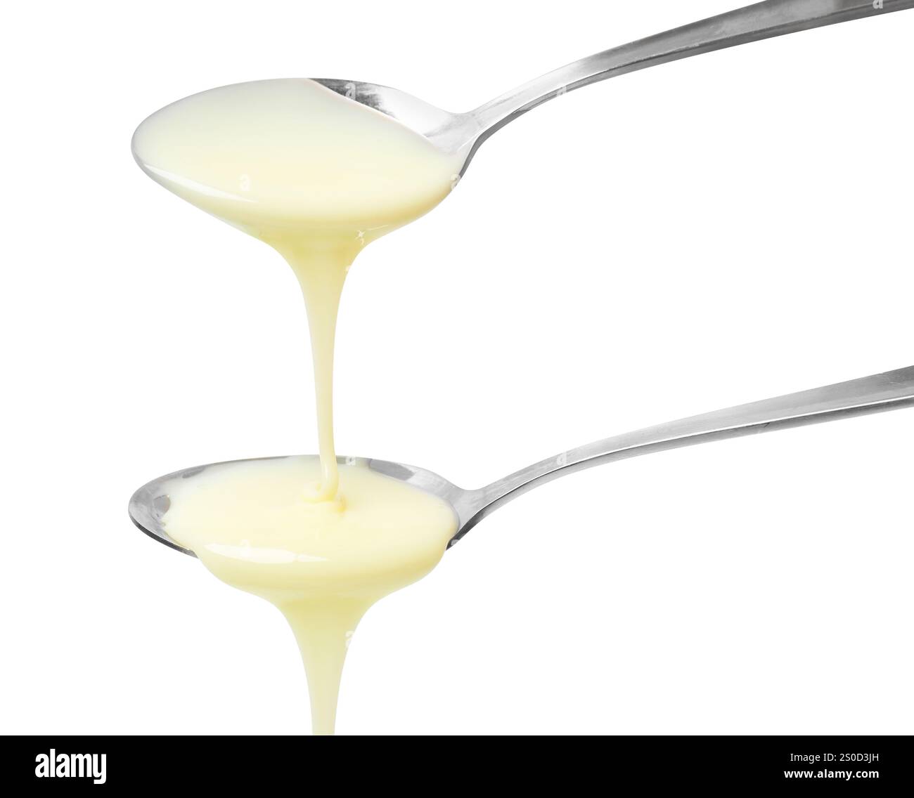 Condensed milk flowing down from spoons isolated on white Stock Photo ...