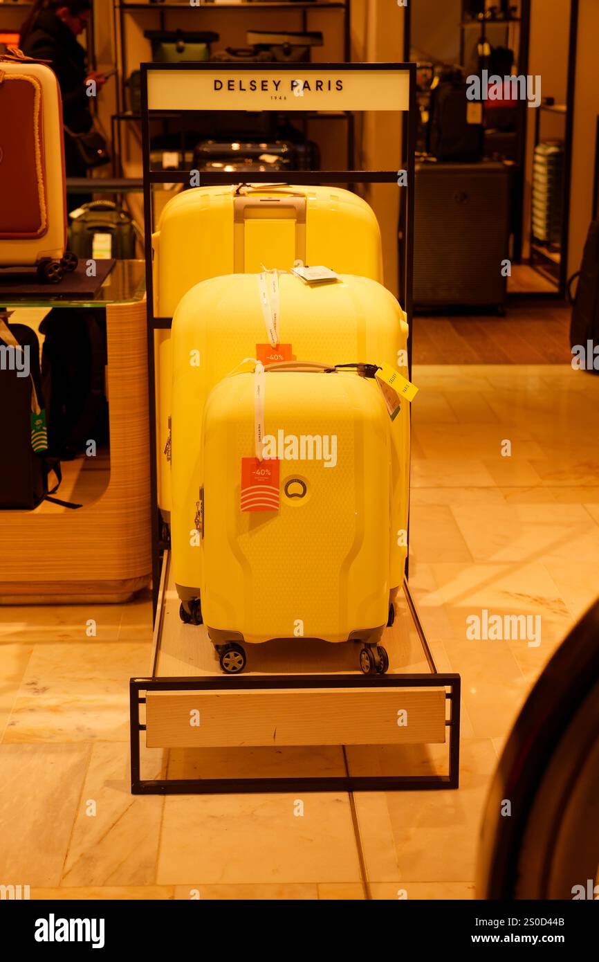 Bright yellow luggage exhibits display in a modern retail store ...