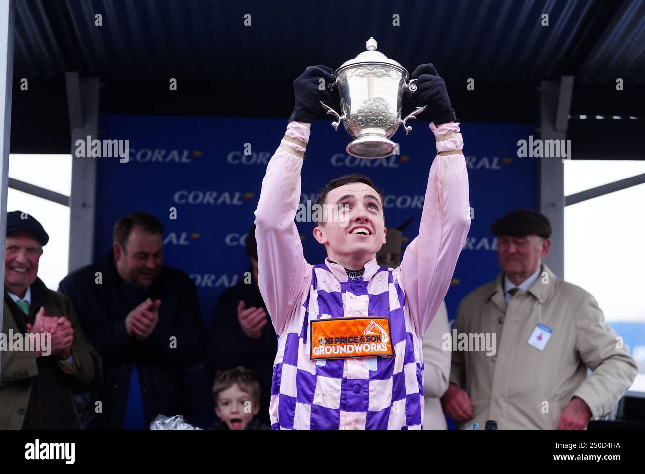 Jockey Charlie Hammond poses for a photo with the trophy after winning ...