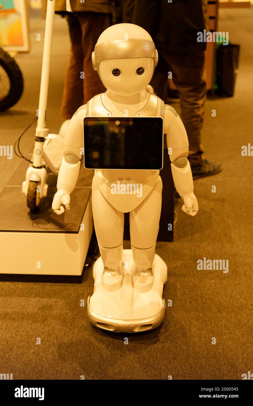 Humanoid robot with tablet interface navigating a modern indoor space ...