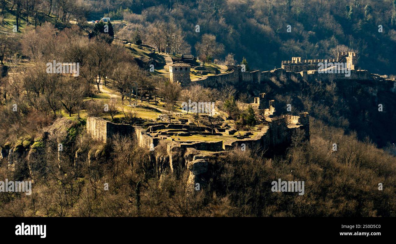 Aerial view of a medieval fortress surrounded by dense forest, with ...