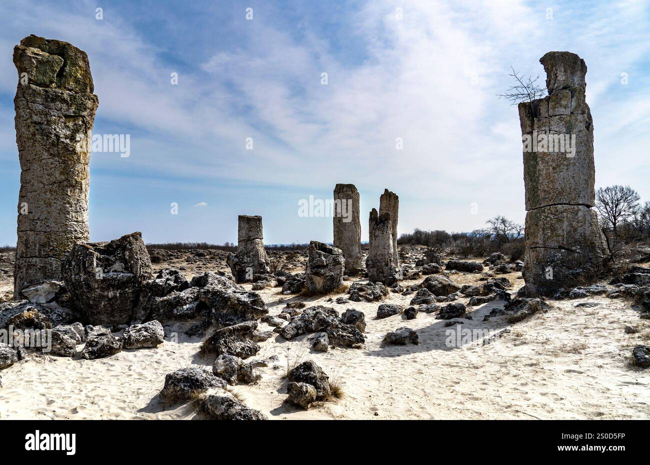 Ancient stone pillars in a desert landscape under a cloudy sky Stock ...