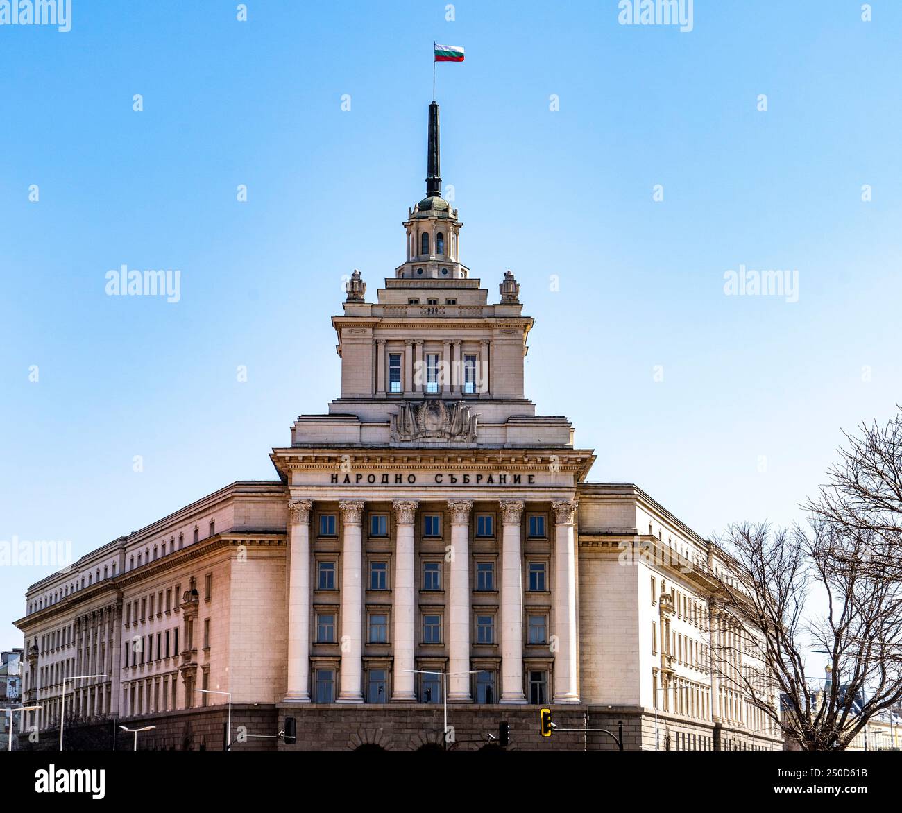 A historic government building with a flag on top, featuring classical ...
