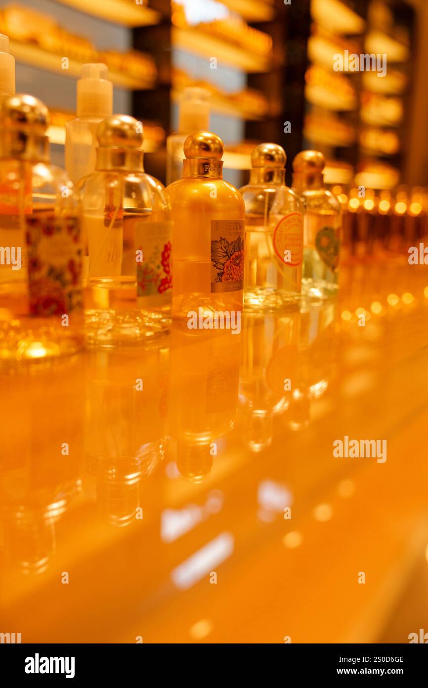 Scented collection of perfumes displayed elegantly on a reflective ...