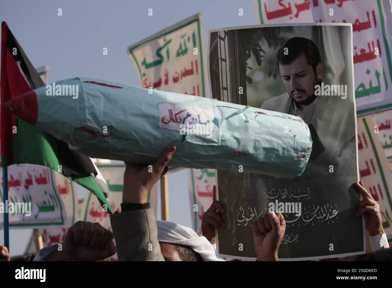 27 December 2024, Yemen, Sana'a: Yemen's Houthi supporters carry a ...