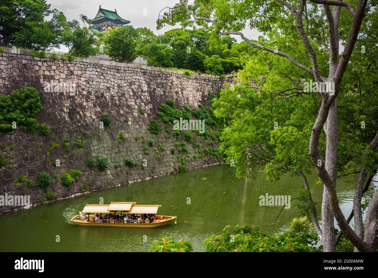 Osaka, Japan, Jun 23, 2024: Tourist ride on a yellow boat on the inner ...