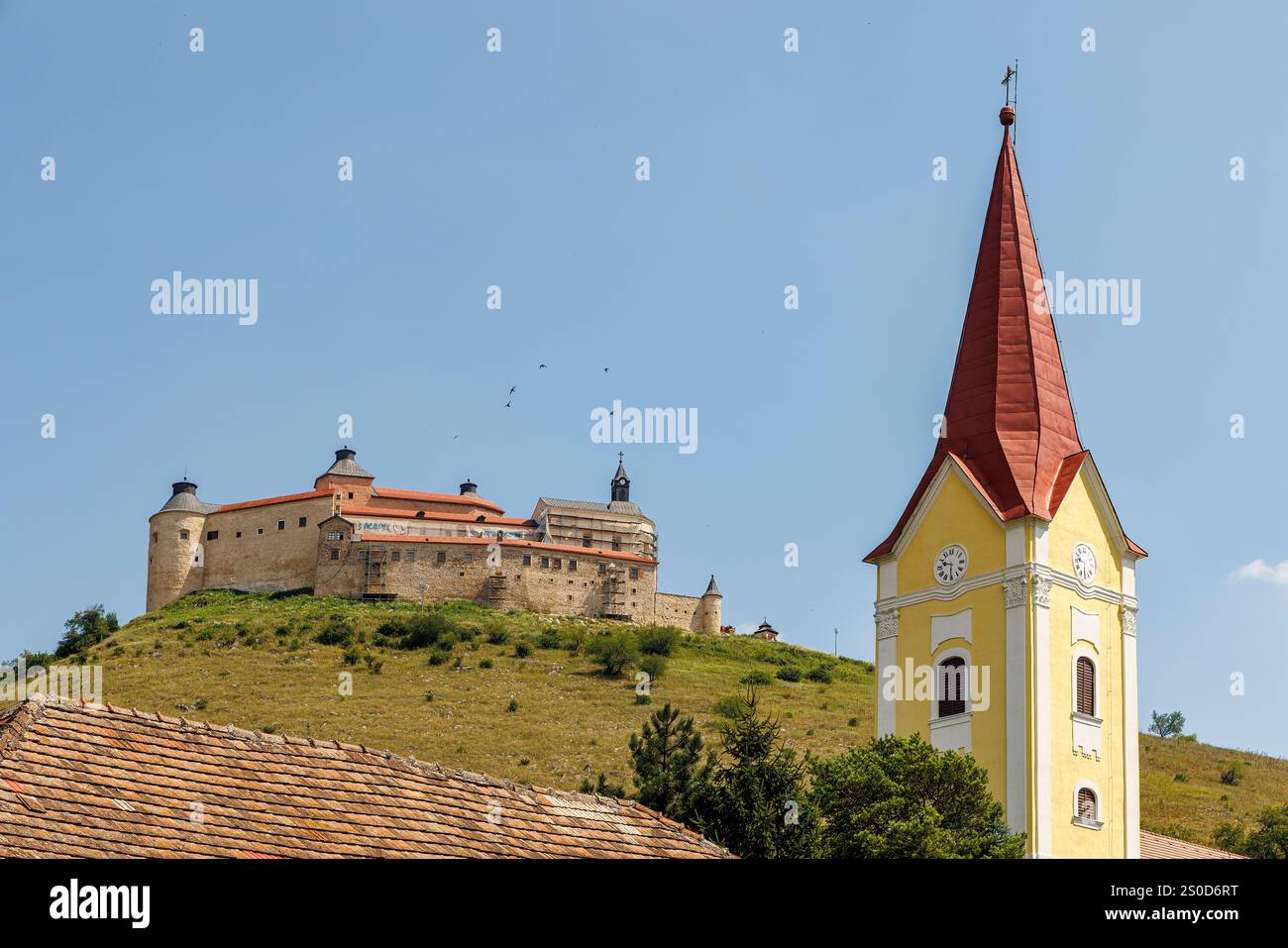 Church steeple with Krásna Hôrka castle, Krásnohorské Podhradie ...