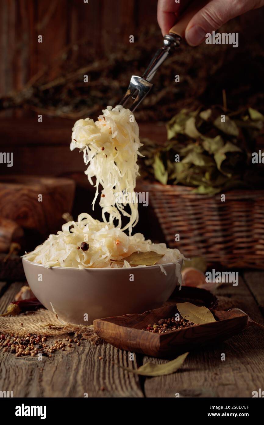 Traditional German sauerkraut with spices on a old rustic wooden table ...