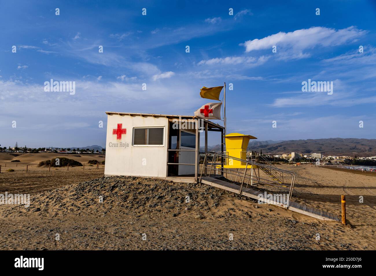 Scenic view of an iconic yellow lifeguard tower with yellow flag on ...