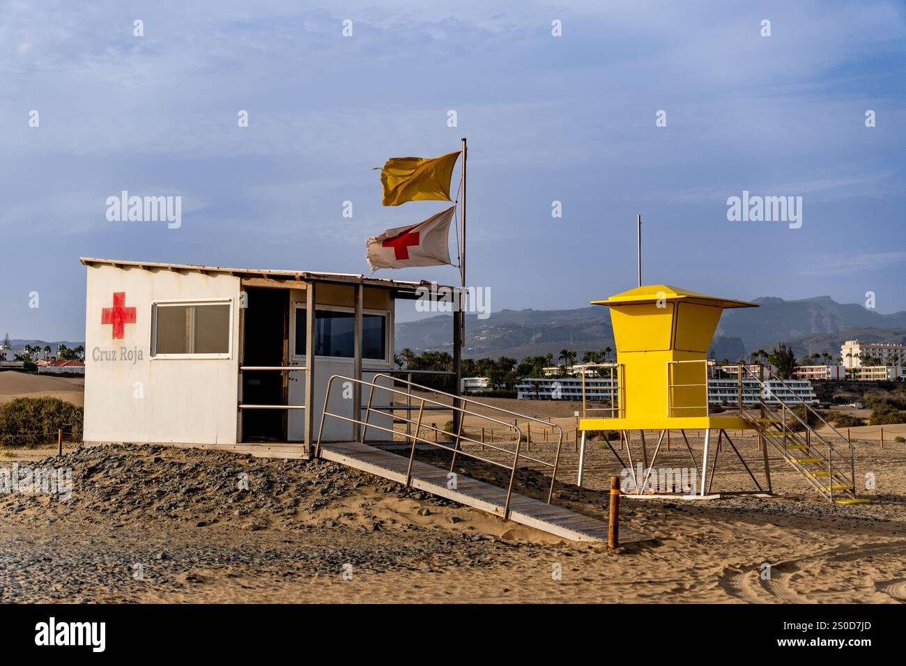 Scenic view of an iconic yellow lifeguard tower with yellow flag on ...