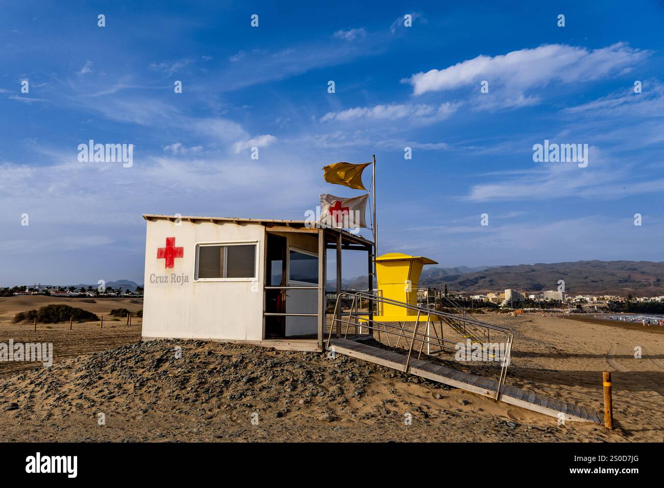 Scenic view of an iconic yellow lifeguard tower with yellow flag on ...