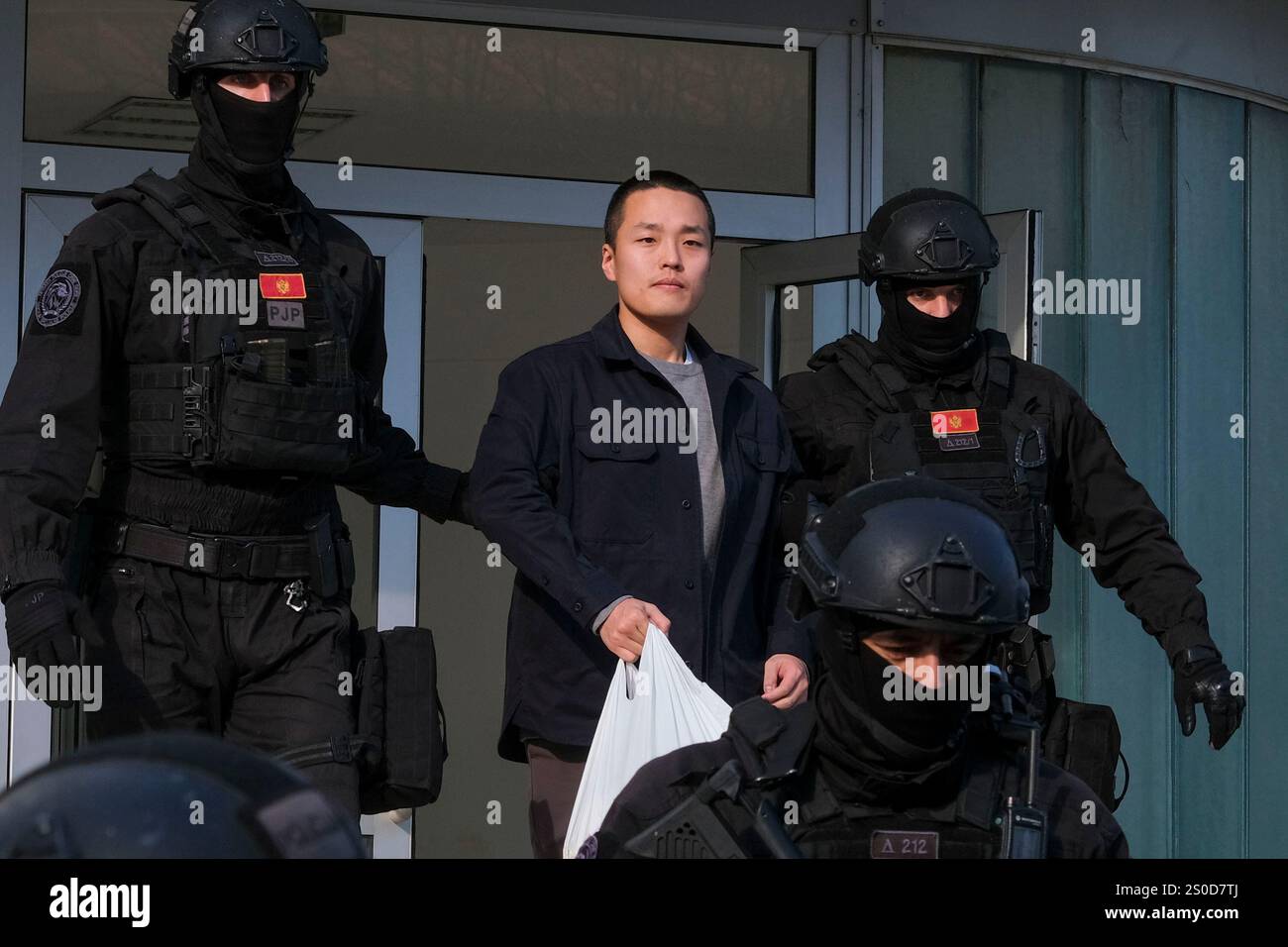 FILE - Montenegrin police officers escort South Korean citizen ...