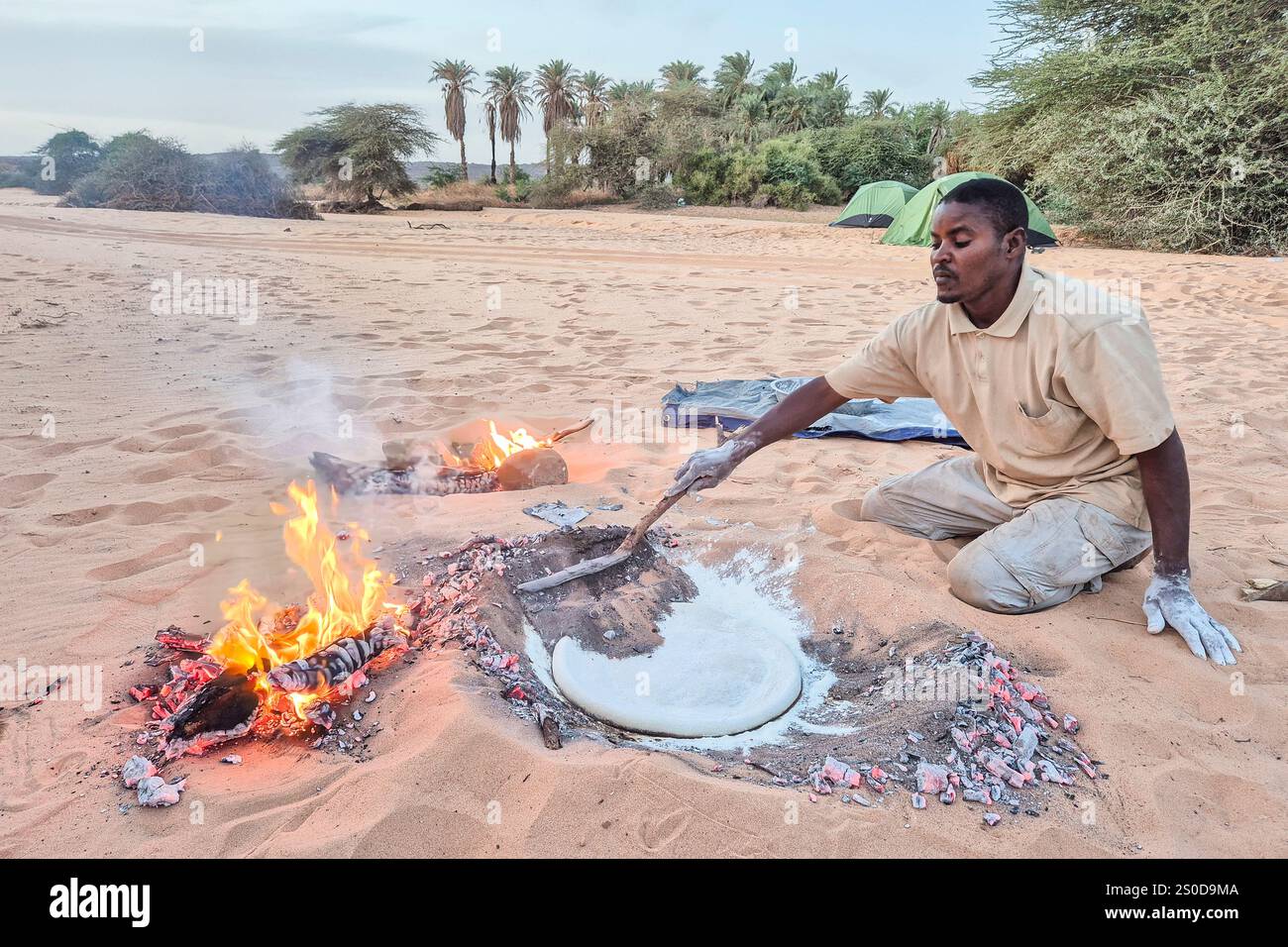 Mauritania, Azweiga, cook preparing traditional desert bread cooked ...