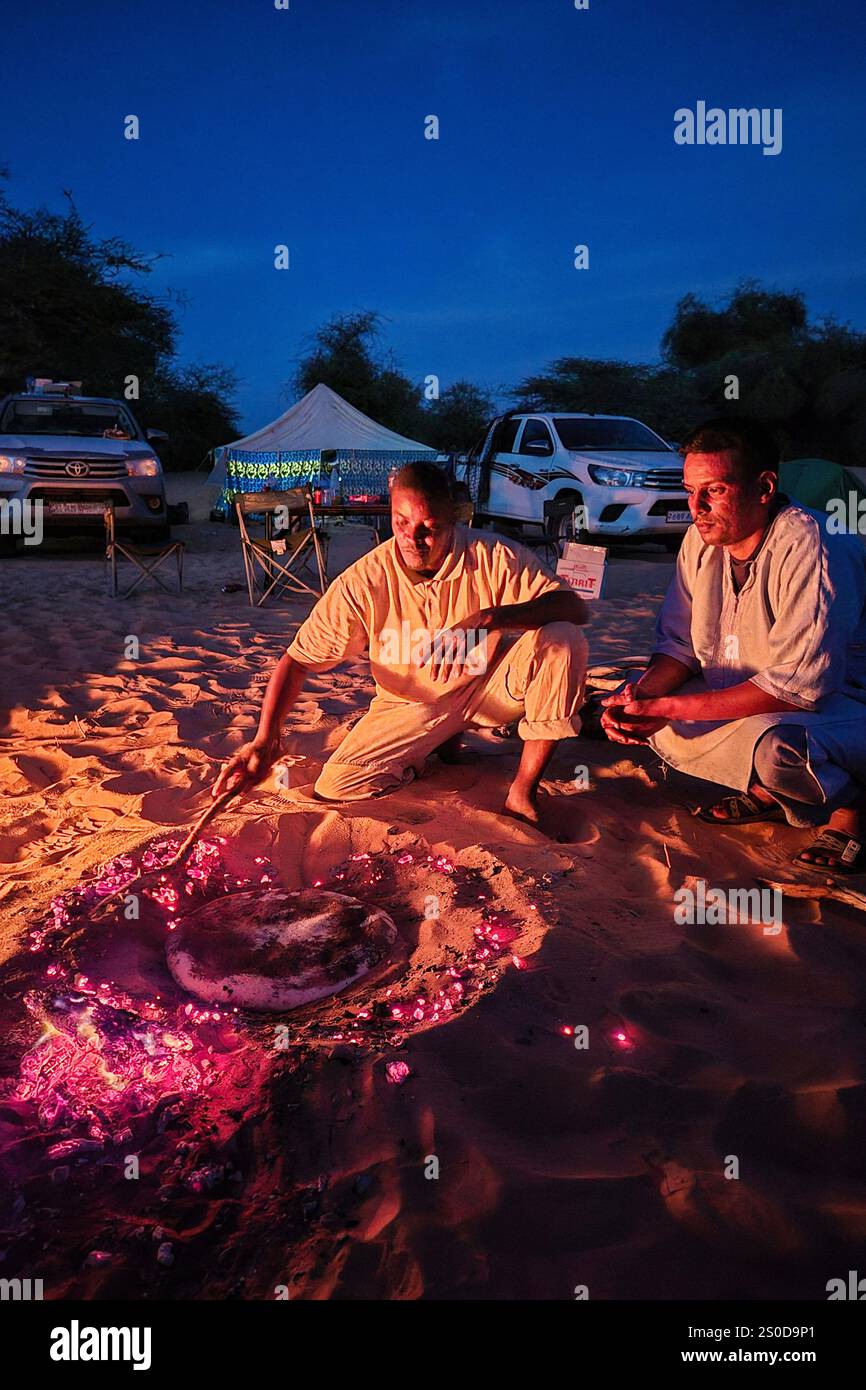 Mauritania, Azweiga, cook preparing traditional desert bread cooked ...