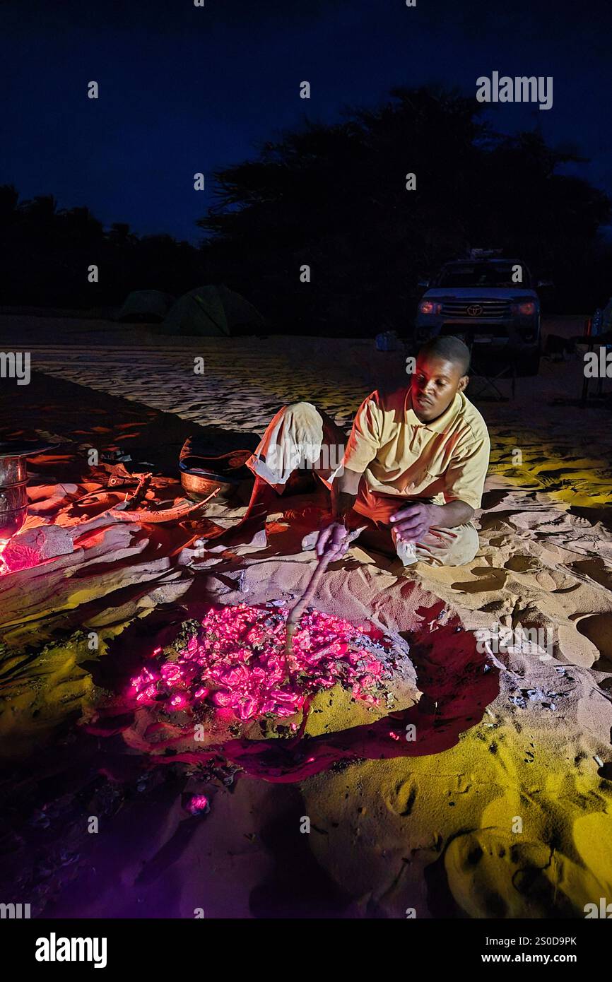 Mauritania, Azweiga, cook preparing traditional desert bread cooked ...