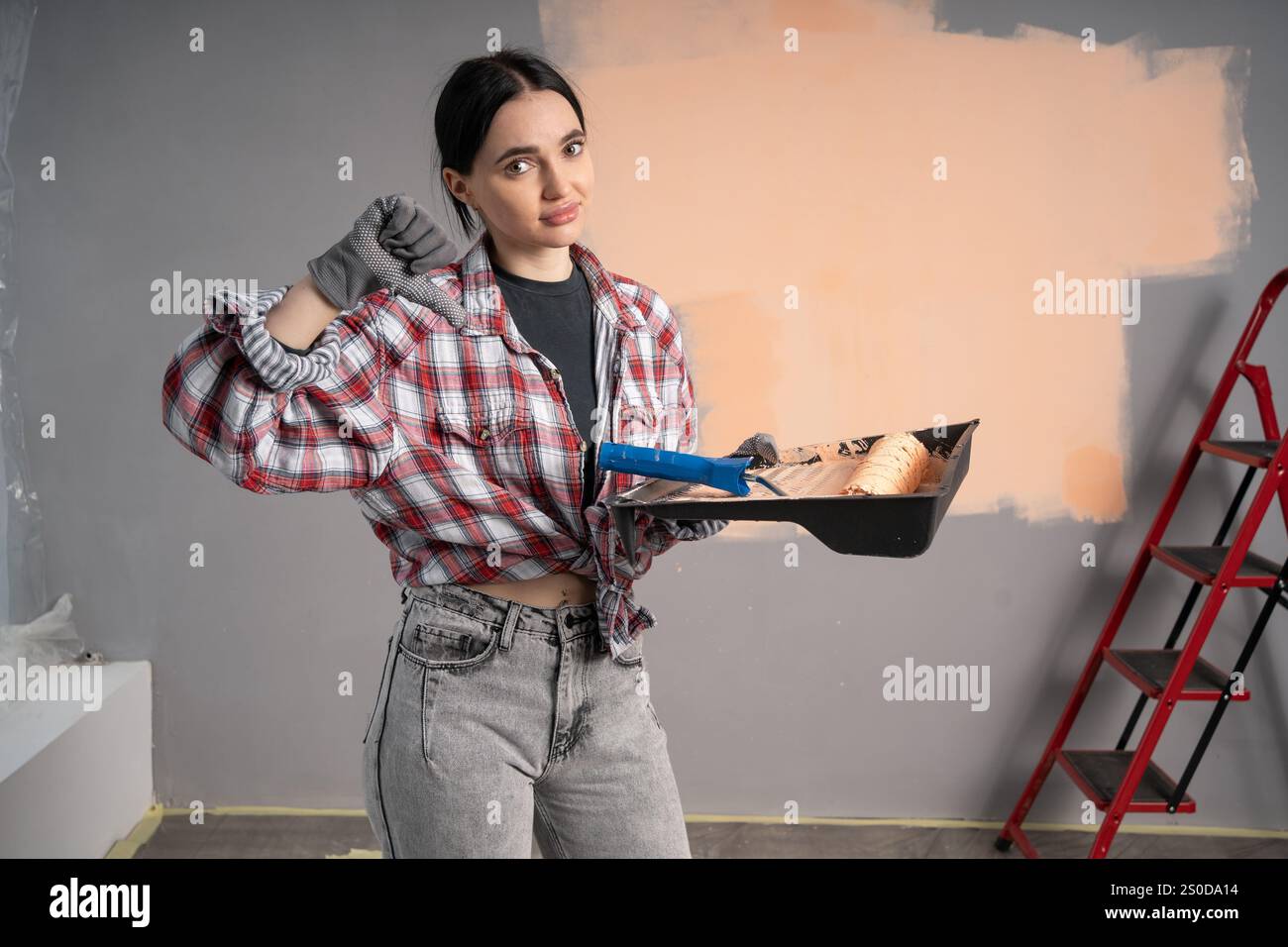 Surprised shocked female painter with roller. Redecoration, renovation ...