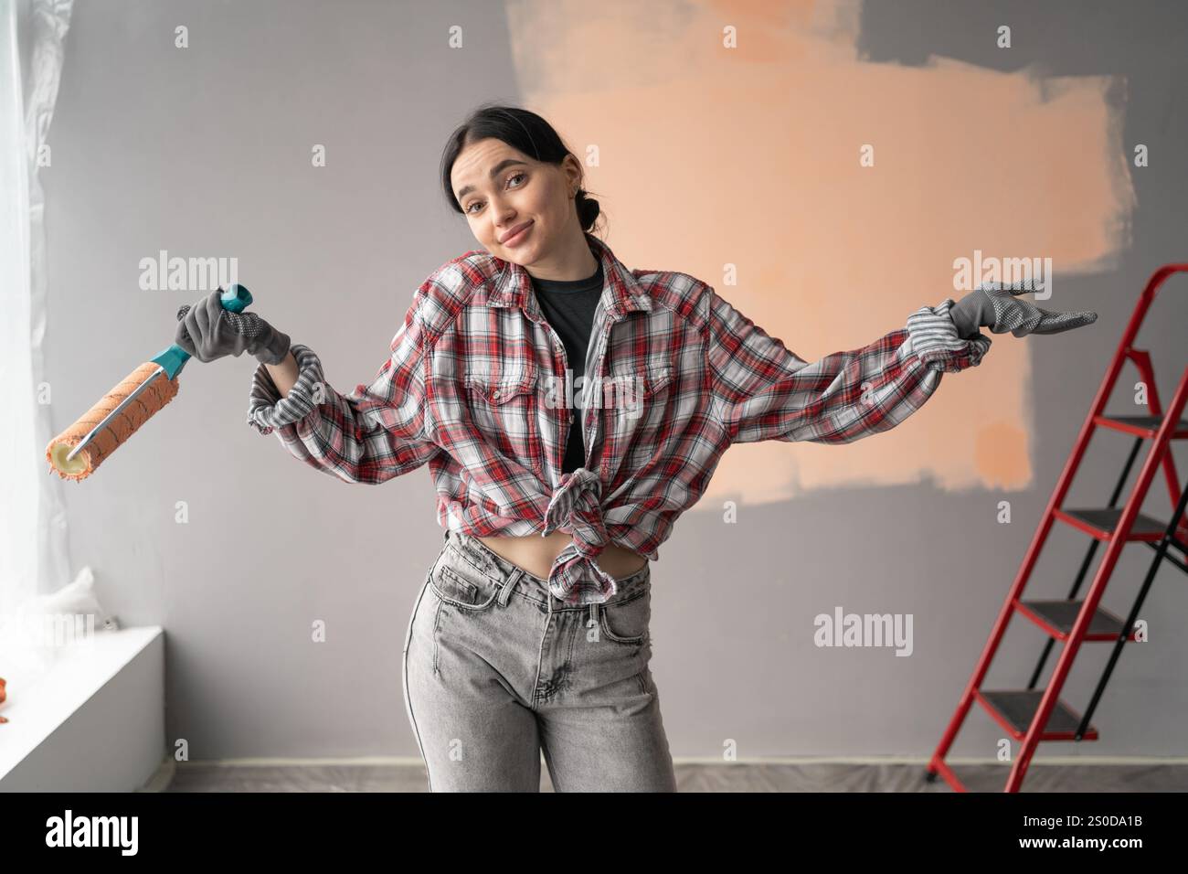 Surprised young woman doing home renovations. Redecorating Stock Photo ...
