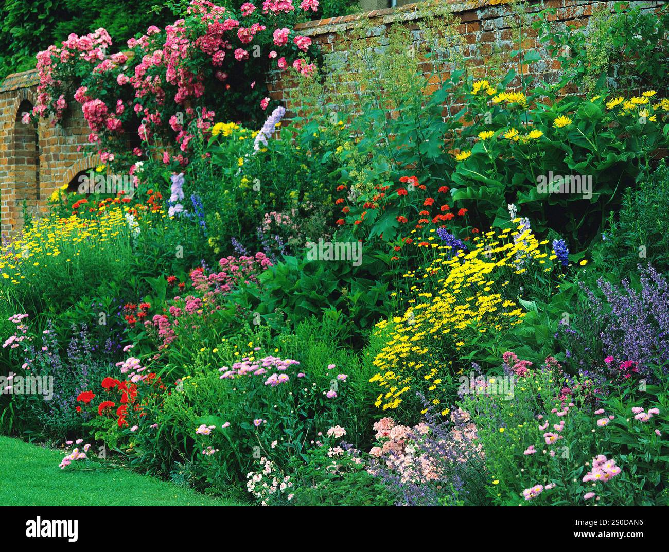 Well planted fowers in a Walled border of avCounrty House Stock Photo ...