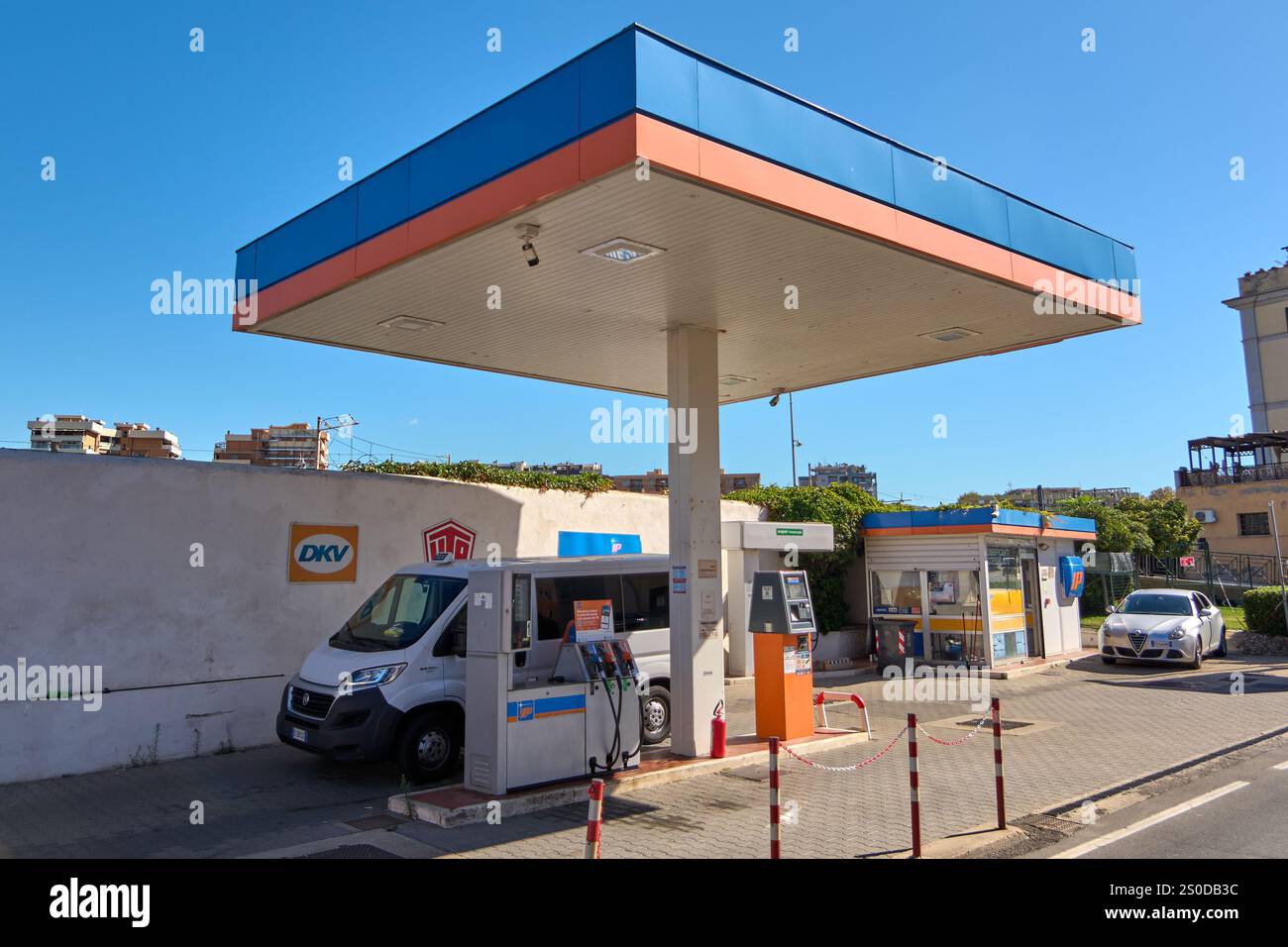 Civitavecchia. Italia - December 17, 2024: White van refueling at urban ...