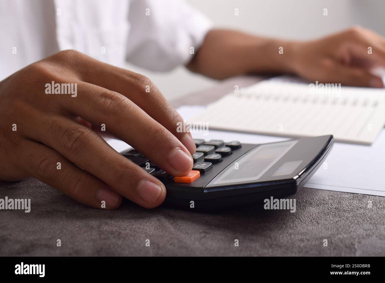 Close-up businessman's hands using calculator to calculate home finance ...