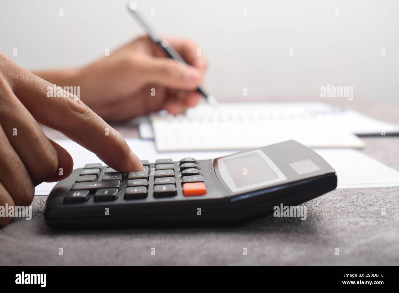 Man using calculator to count income and outcome Stock Photo - Alamy