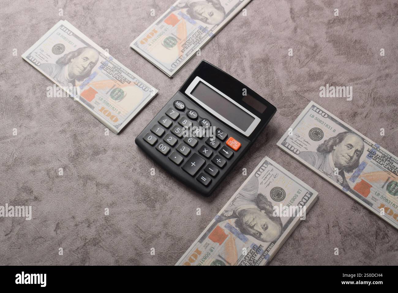 Calculator and dollars stack isolated on dark gray background. Personal ...