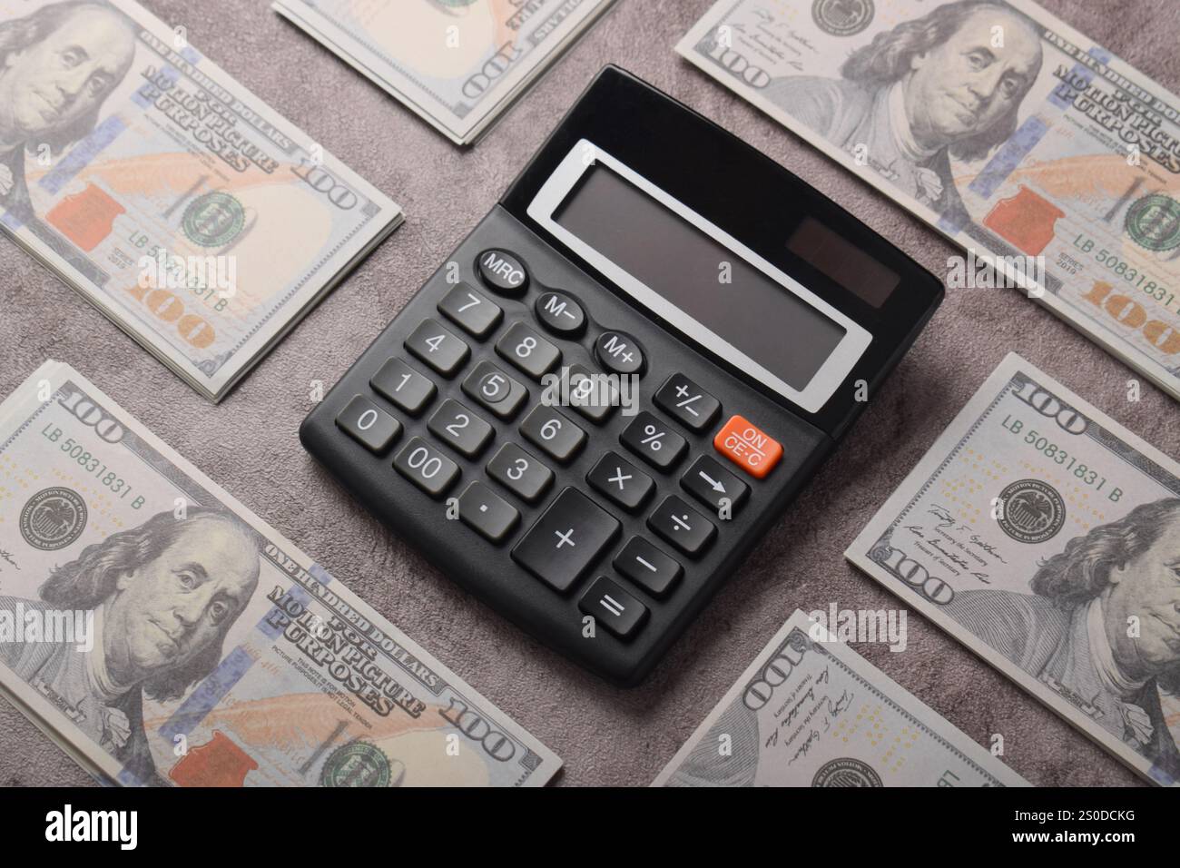 Calculator and dollars stack isolated on dark gray background. Personal ...