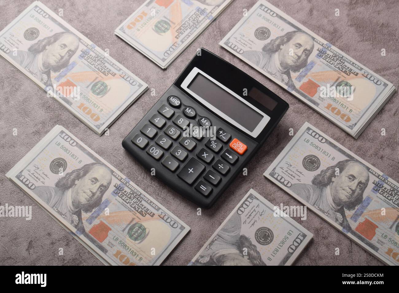 Calculator and dollars stack isolated on dark gray background. Personal ...