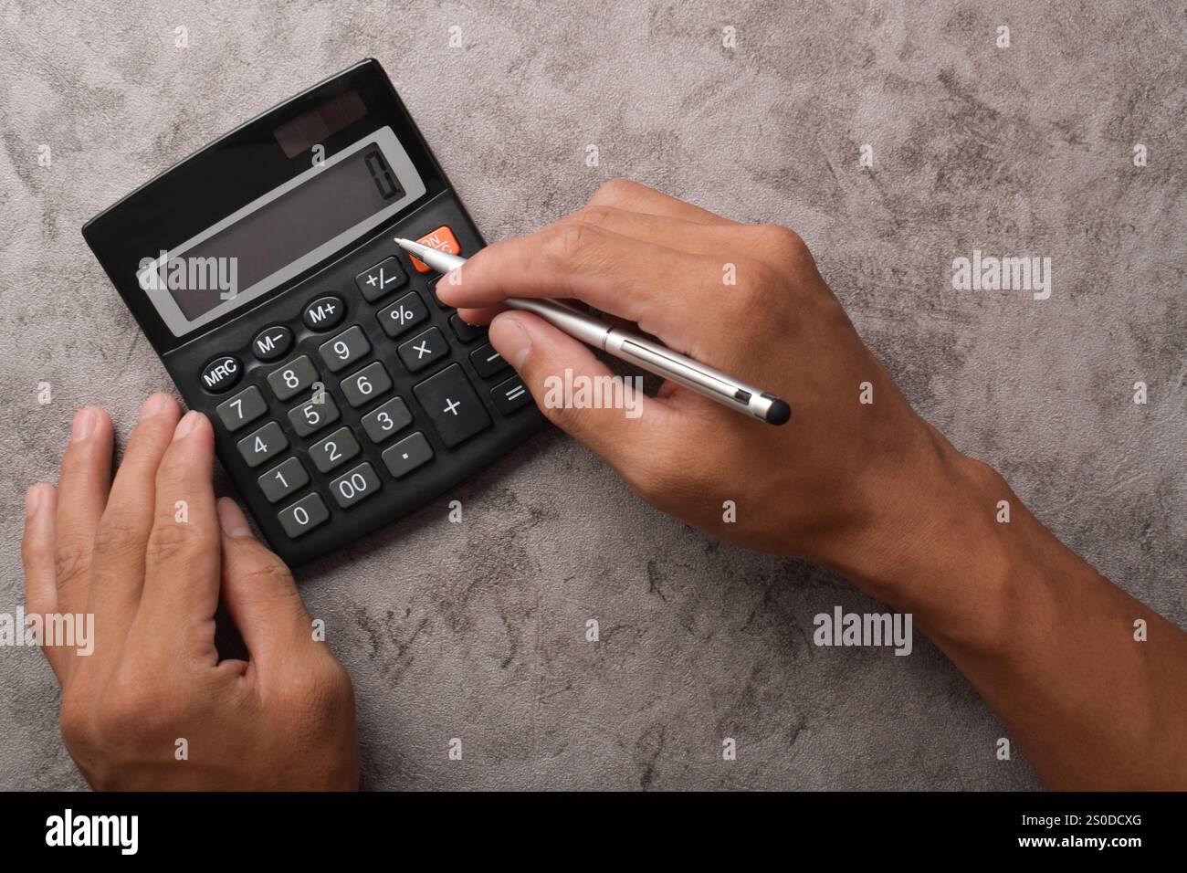 Accountant using calculator on desk office on dark gray background with ...