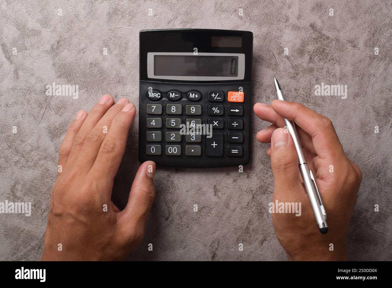 Accountant using calculator on desk office on dark gray background with ...