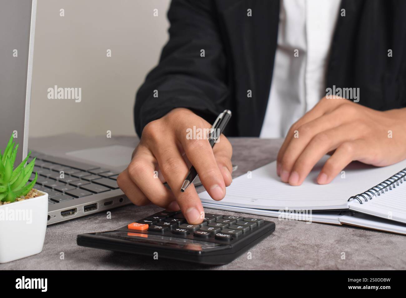 Businessmans hands using calculator hi-res stock photography and images ...