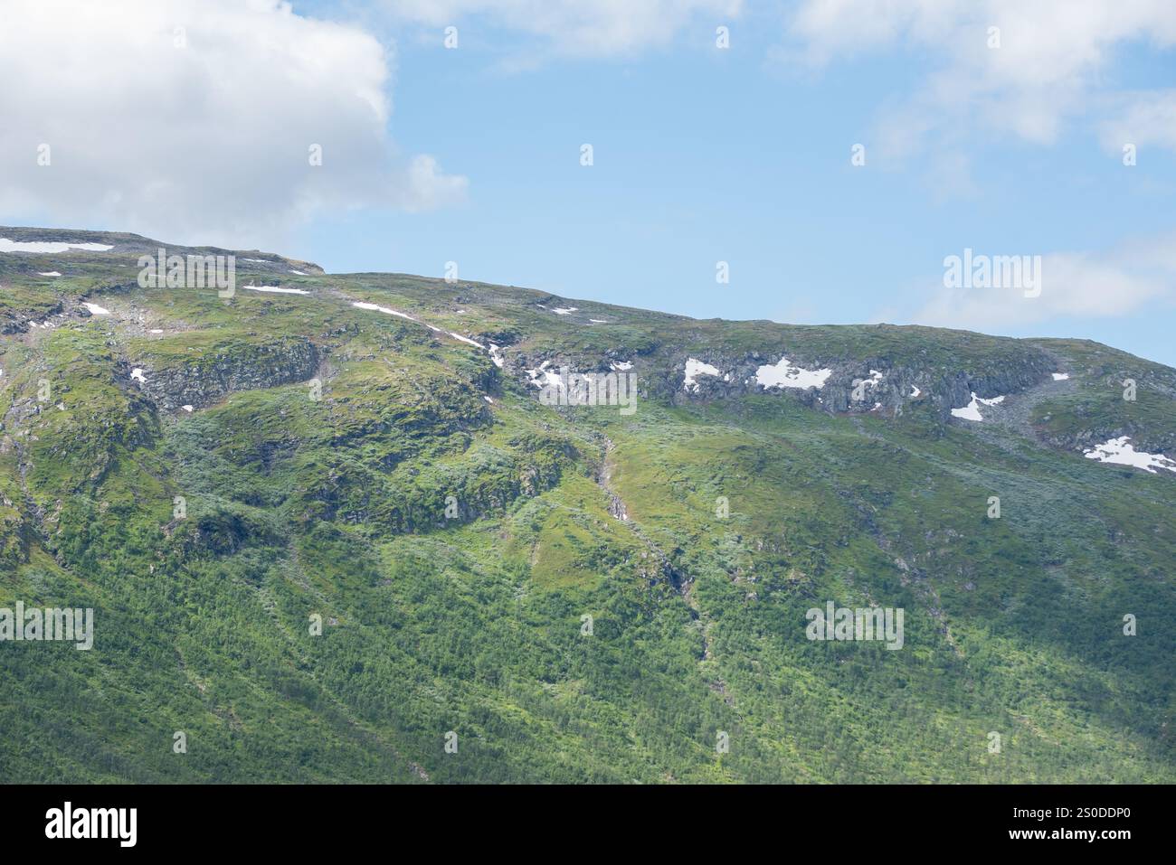 mountain cliff with snow on it and visible avalanches. A natural ...