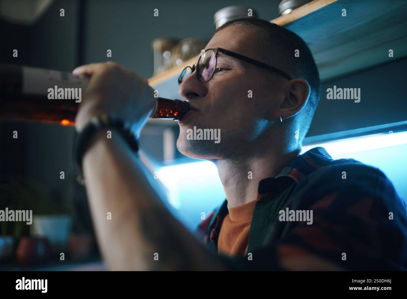 Guy drinking beer from bottle while visiting to home party Stock Photo ...