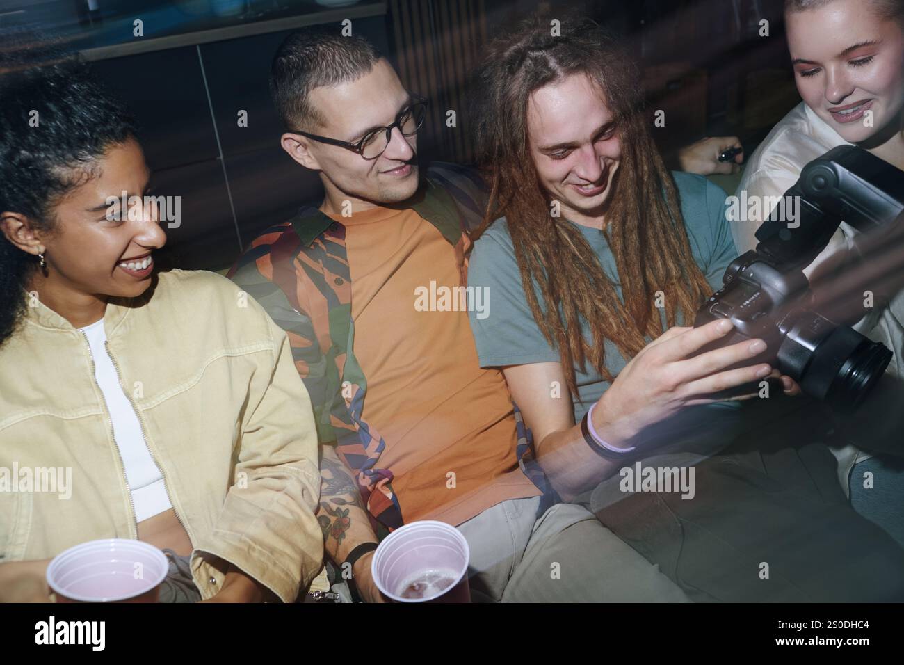 Guy watching photos together with his friends during home party Stock ...
