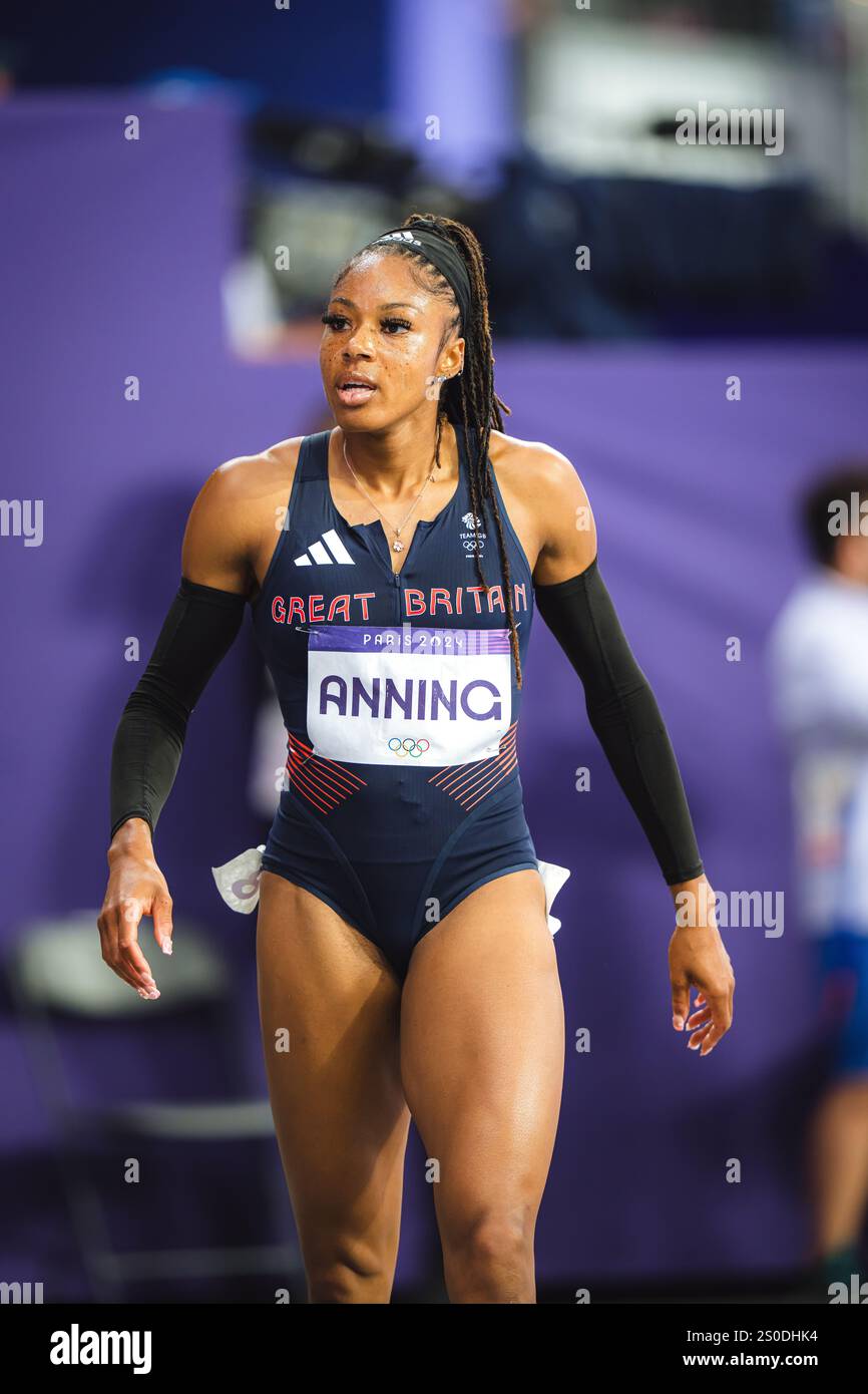 Amber Anning celebrating with her country's flag in the 4x400 meters ...