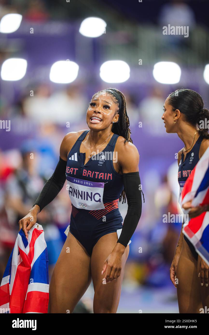 Amber Anning celebrating with her country's flag in the 4x400 meters ...