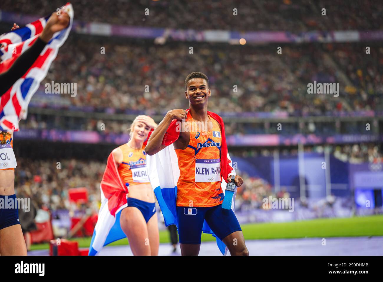 Isayah Klein Ikkink celebrating with her country's flag in the 4x400 ...
