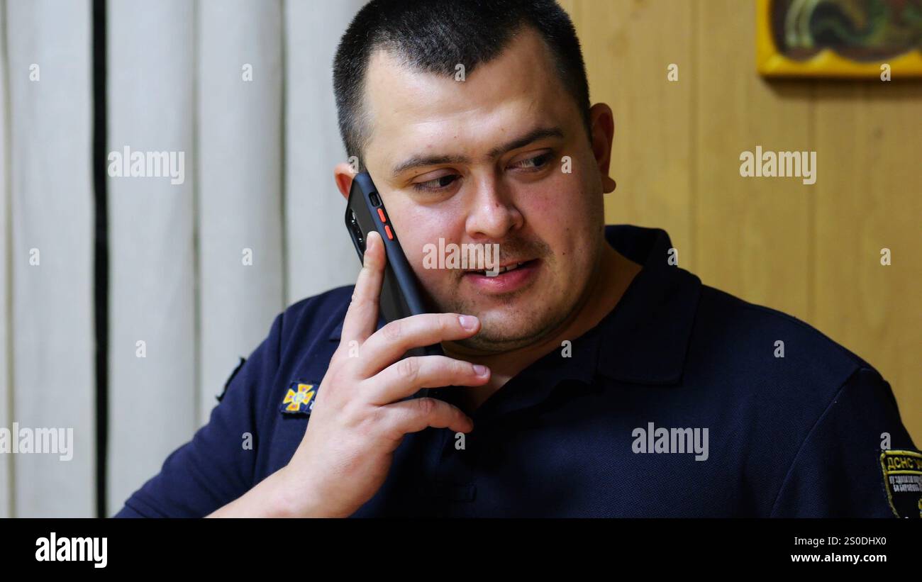 Male firefighter chief have serious telephone conversation with his ...
