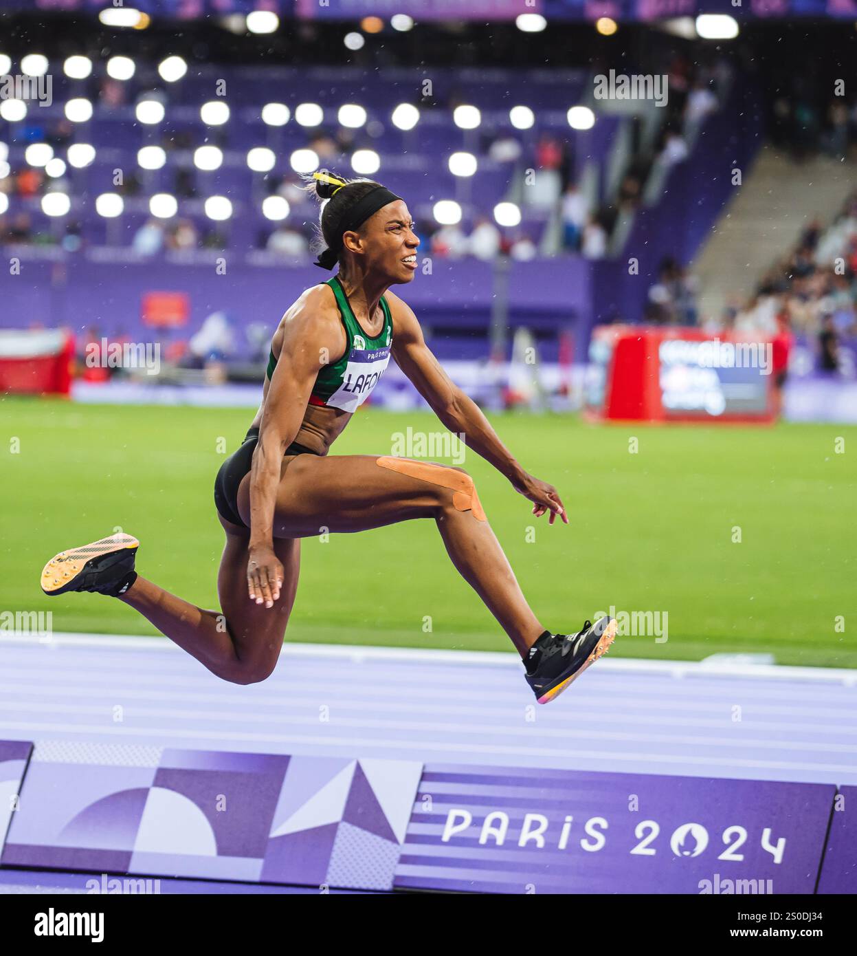 Thea LaFond participating in the triple jump at the Paris 2024 Olympic ...