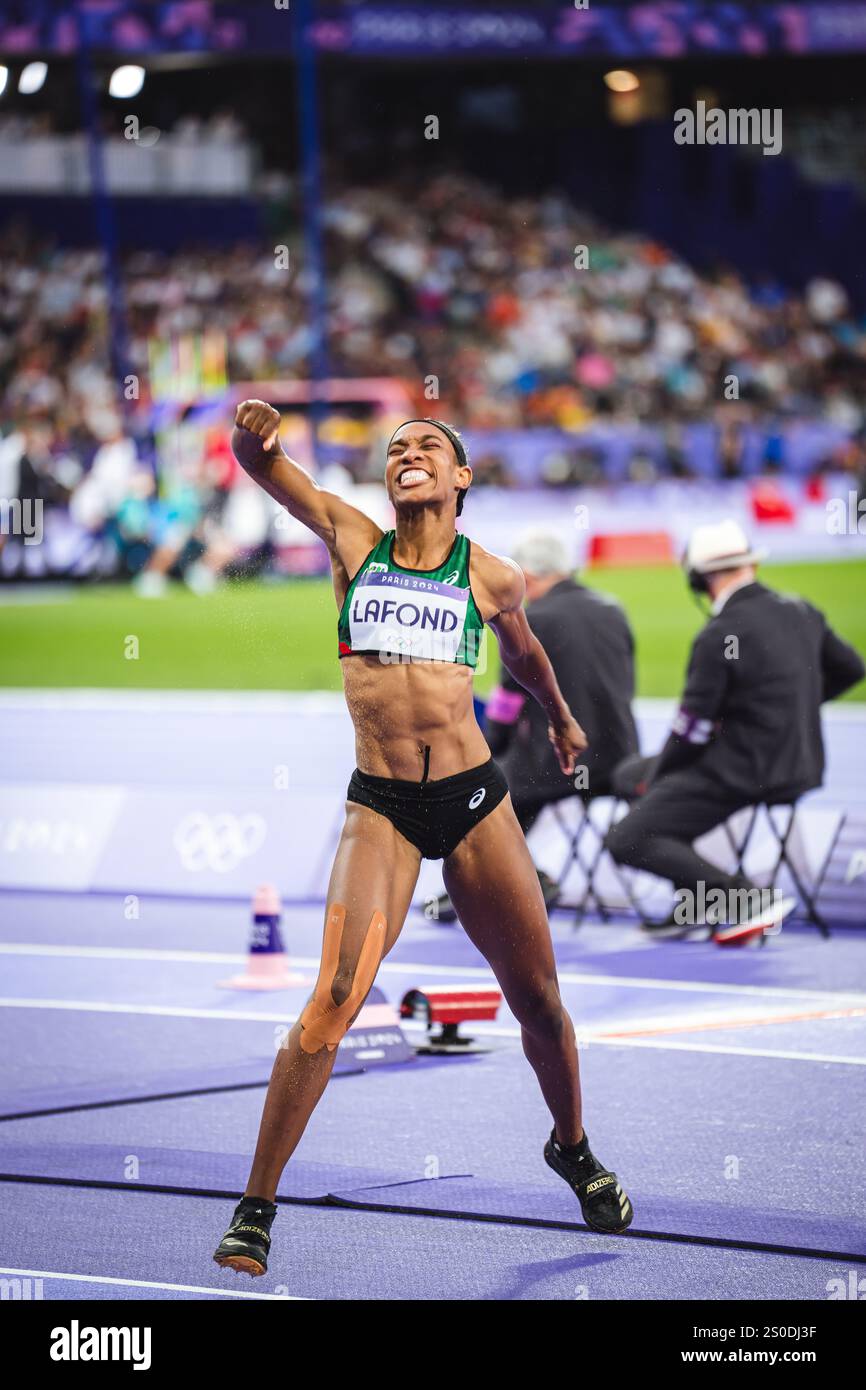 Thea LaFond celebrating her medal with her country's flag at the Paris ...