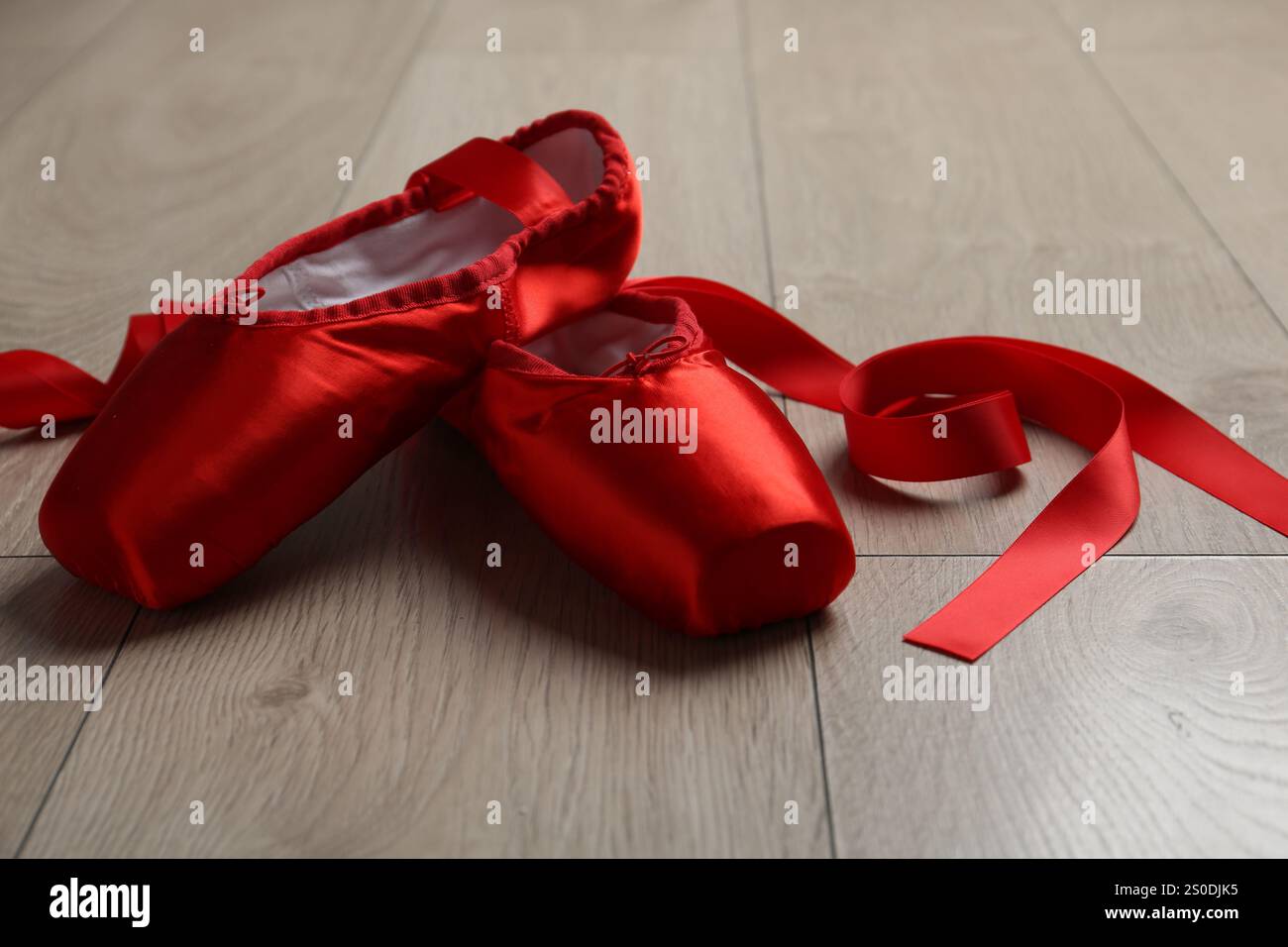 Pair of red pointe shoes on wooden floor Stock Photo - Alamy