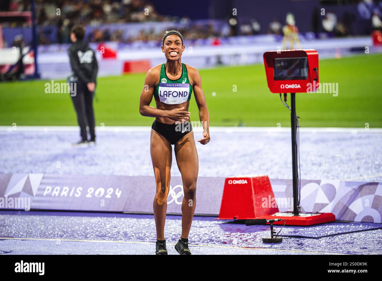 Thea LaFond celebrating her medal with her country's flag at the Paris ...