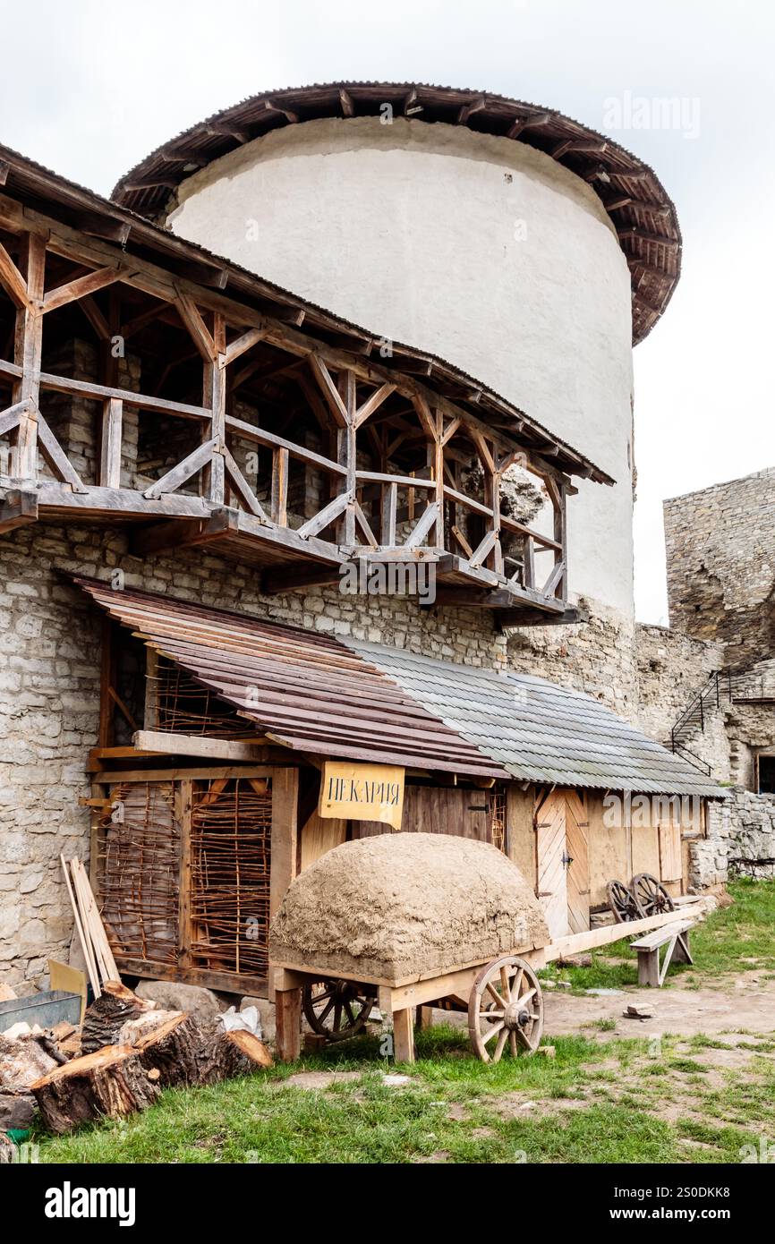 A building with a large, round tower and a sign on the side that says ...