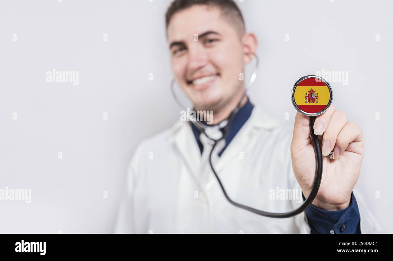 Smiling doctor showing stethoscope with Spain flag. Spain National ...