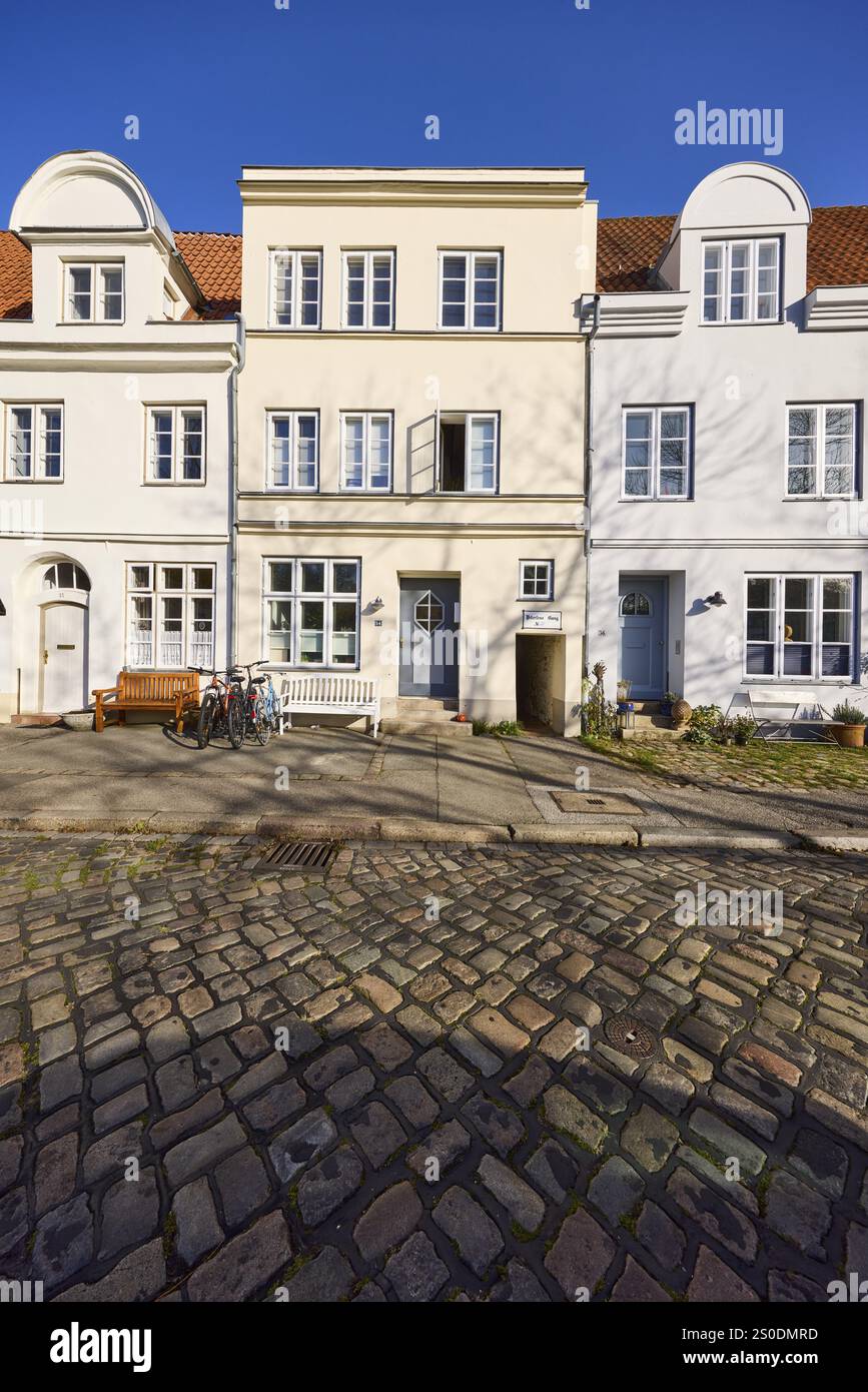 Historic houses, facades with windows, roofs with red roof tiles and ...