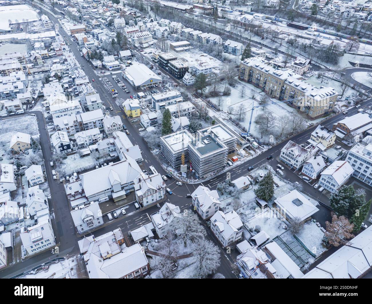 Snowy urban landscape with streets, buildings and trees in winter ...